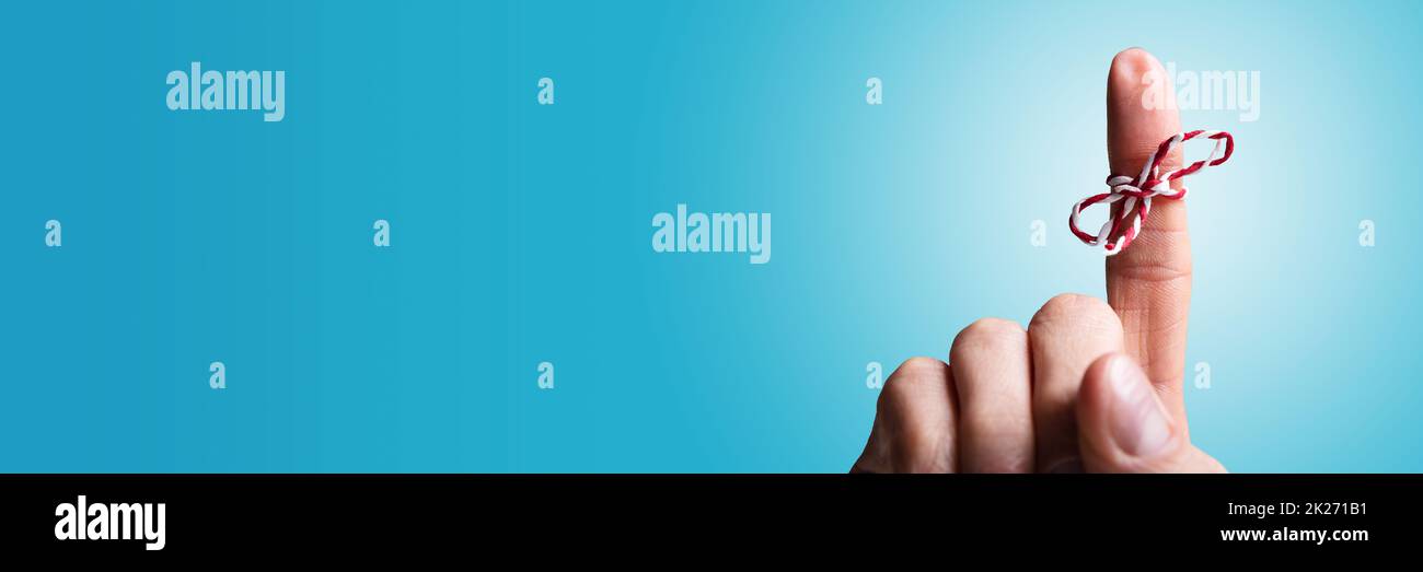 String On Person's Finger Stock Photo - Alamy