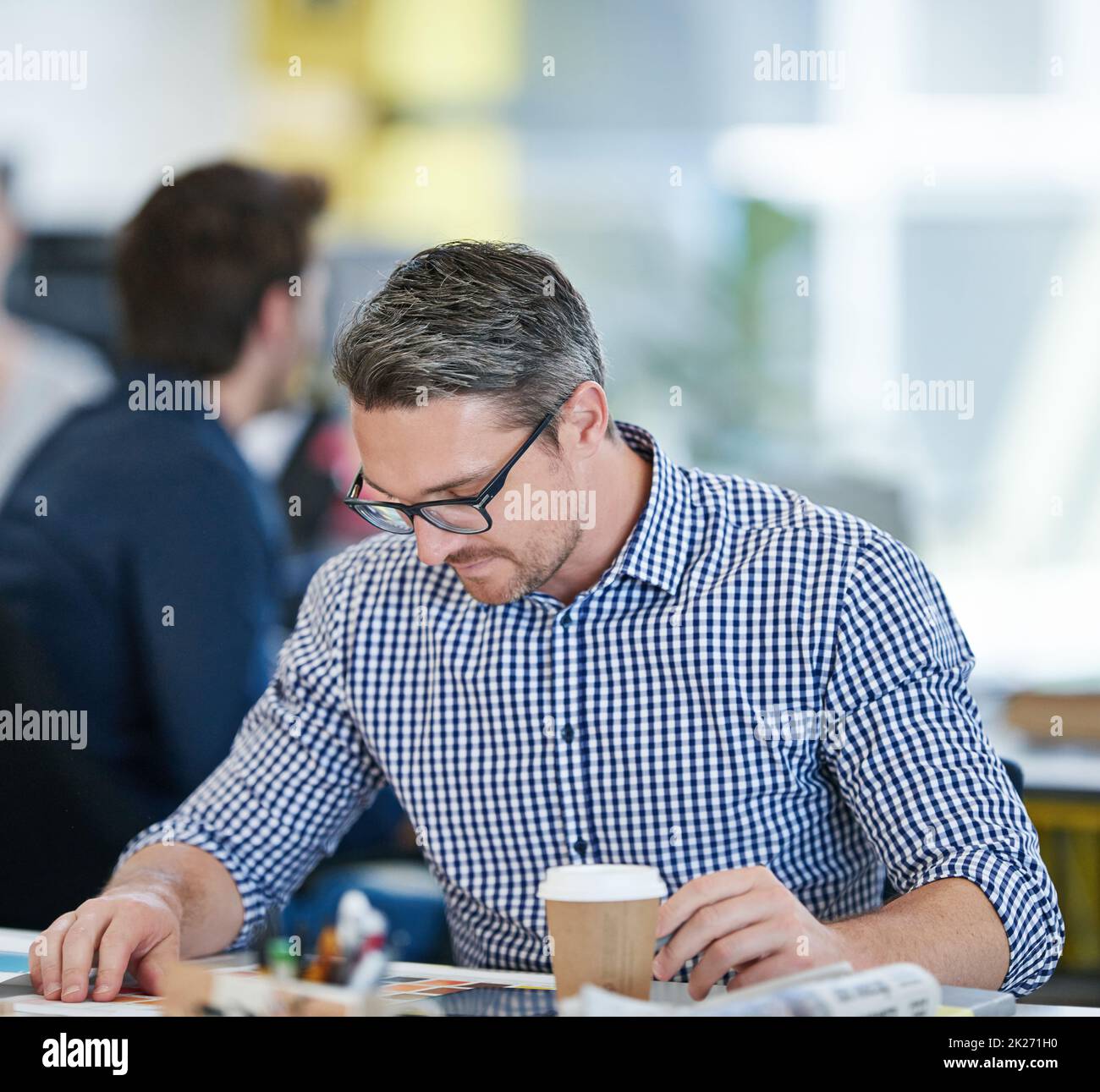 Hes totally immersed in the project. an office worker sitting at his ...