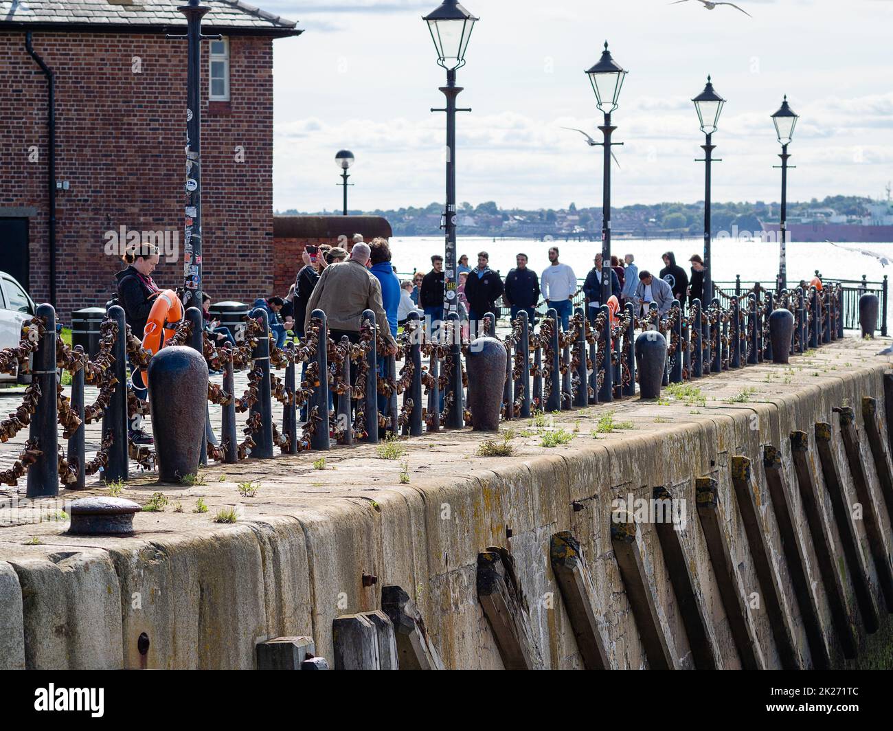 Liverpool UK Sept 2022 groups of people walking along the sea front ...