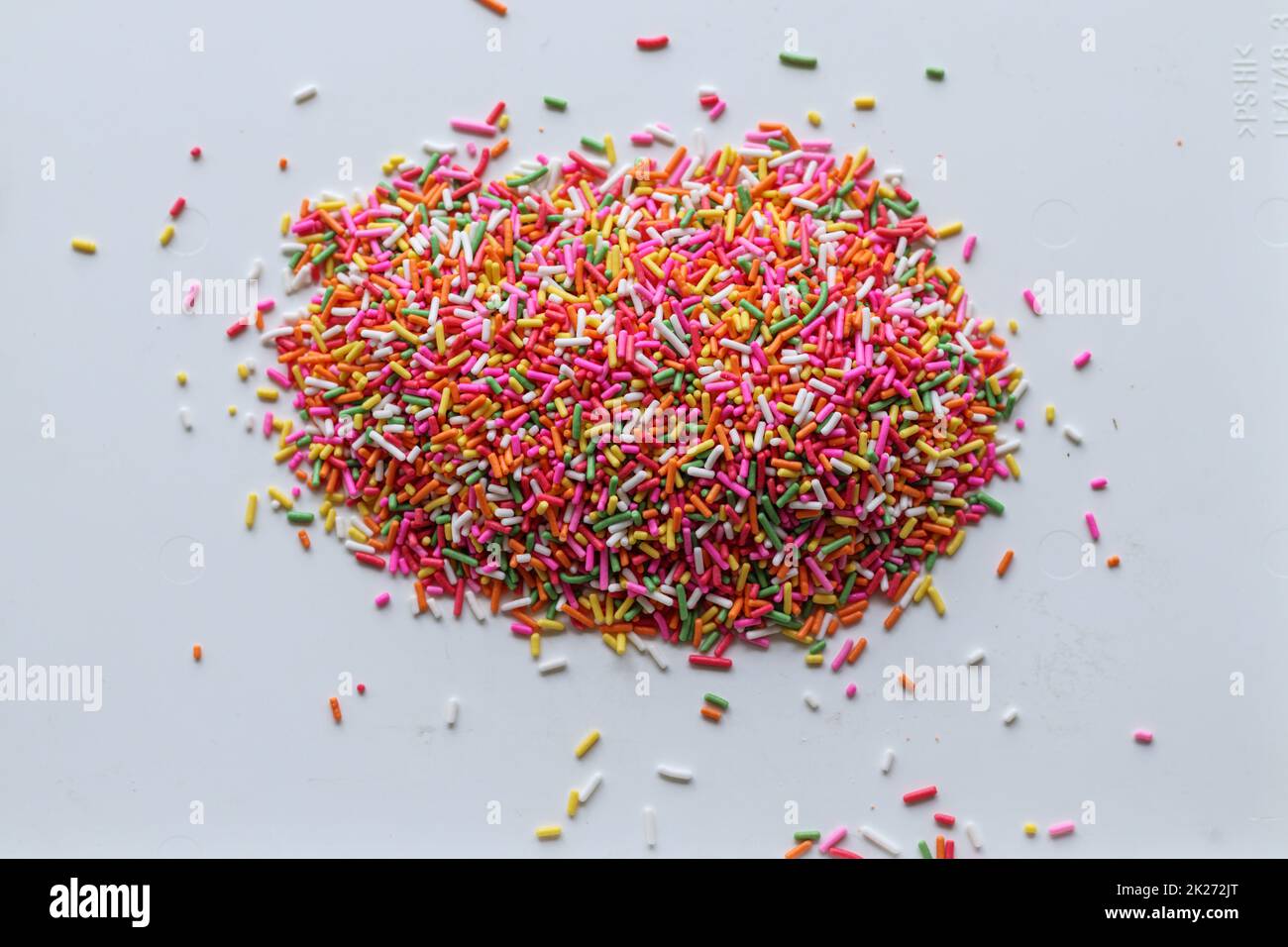Lots of brightly colored sugar granules background used for topping ...