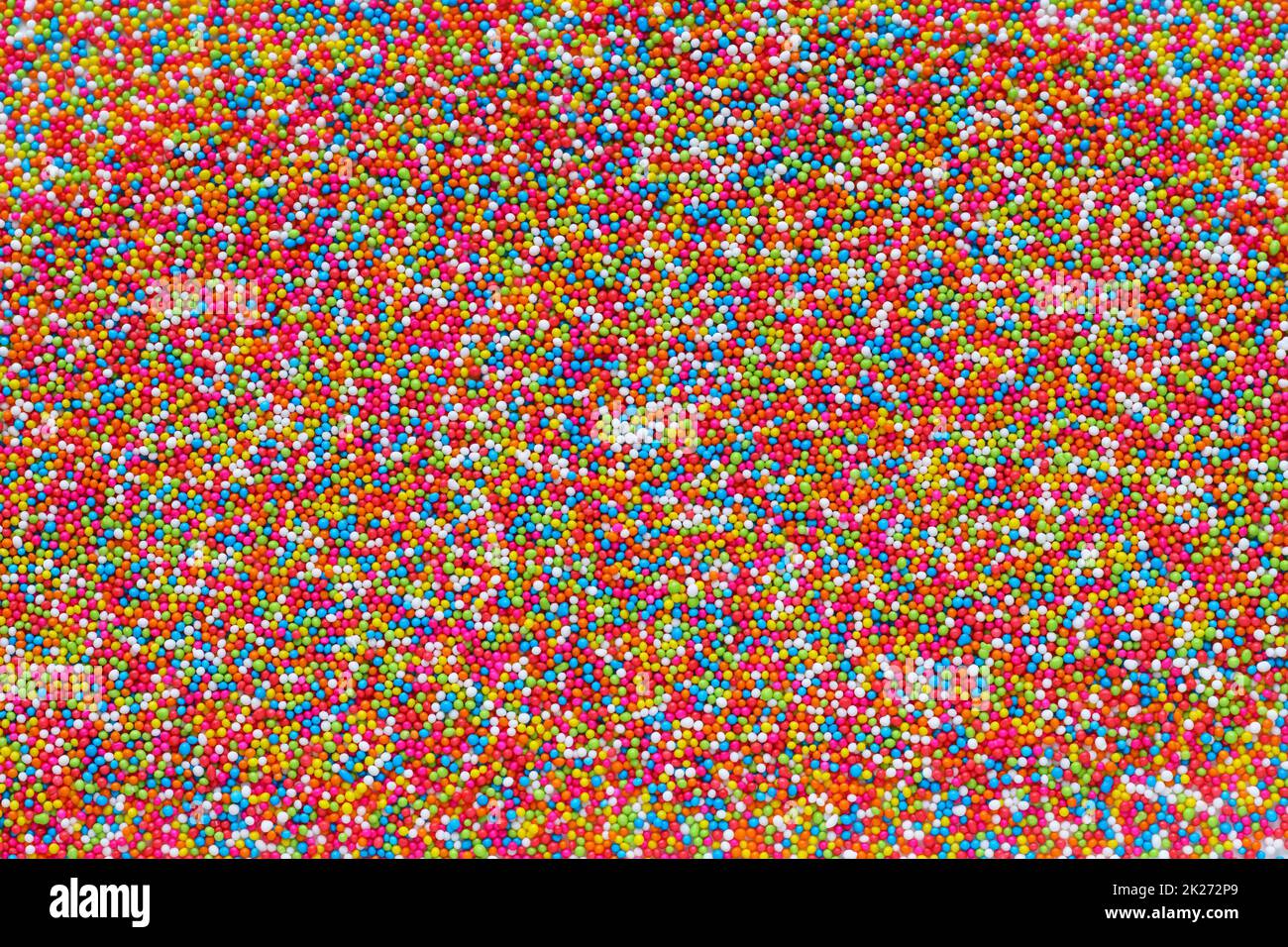Lots of brightly colored sugar granules background used for topping ...