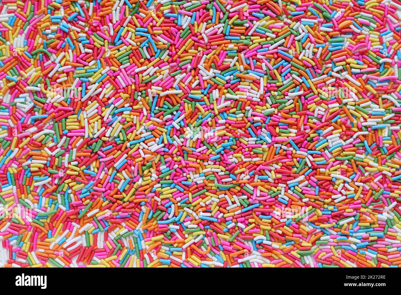 Lots of brightly colored sugar granules background used for topping ...