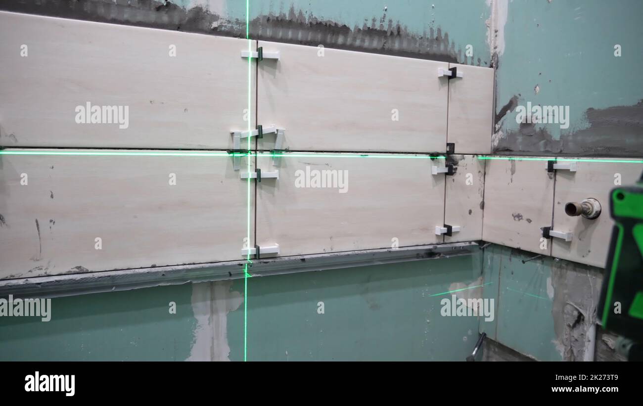 Construction and repair of walls in a new building.Laying wall tiles ...