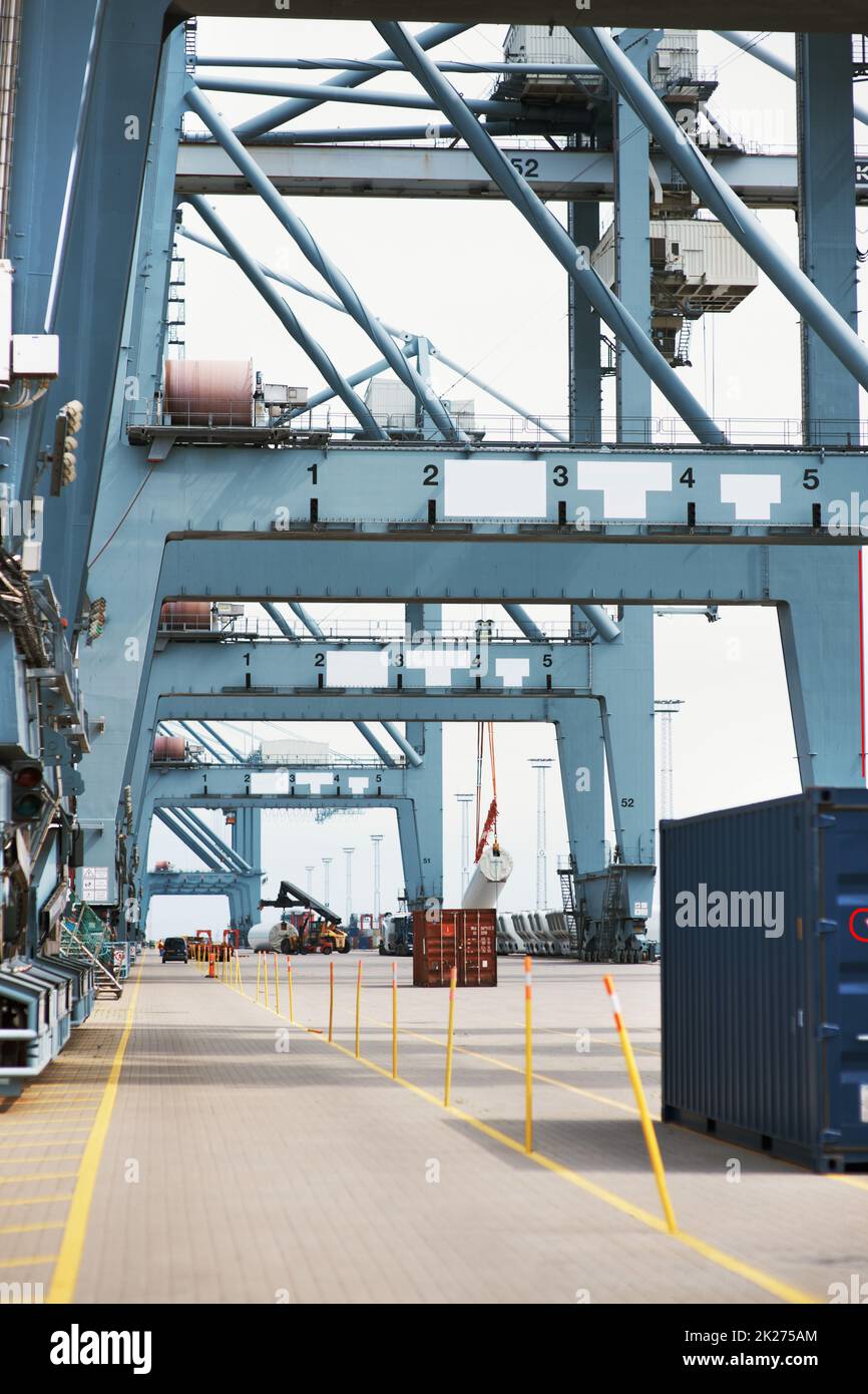 The evolution of engineering. Cranes shipping supplies at the harbor ...