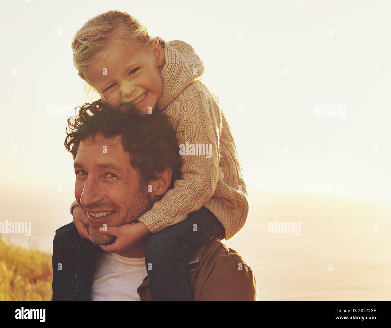 Happy girl sitting on the shoulders of adult male hi-res stock photography and images - Alamy