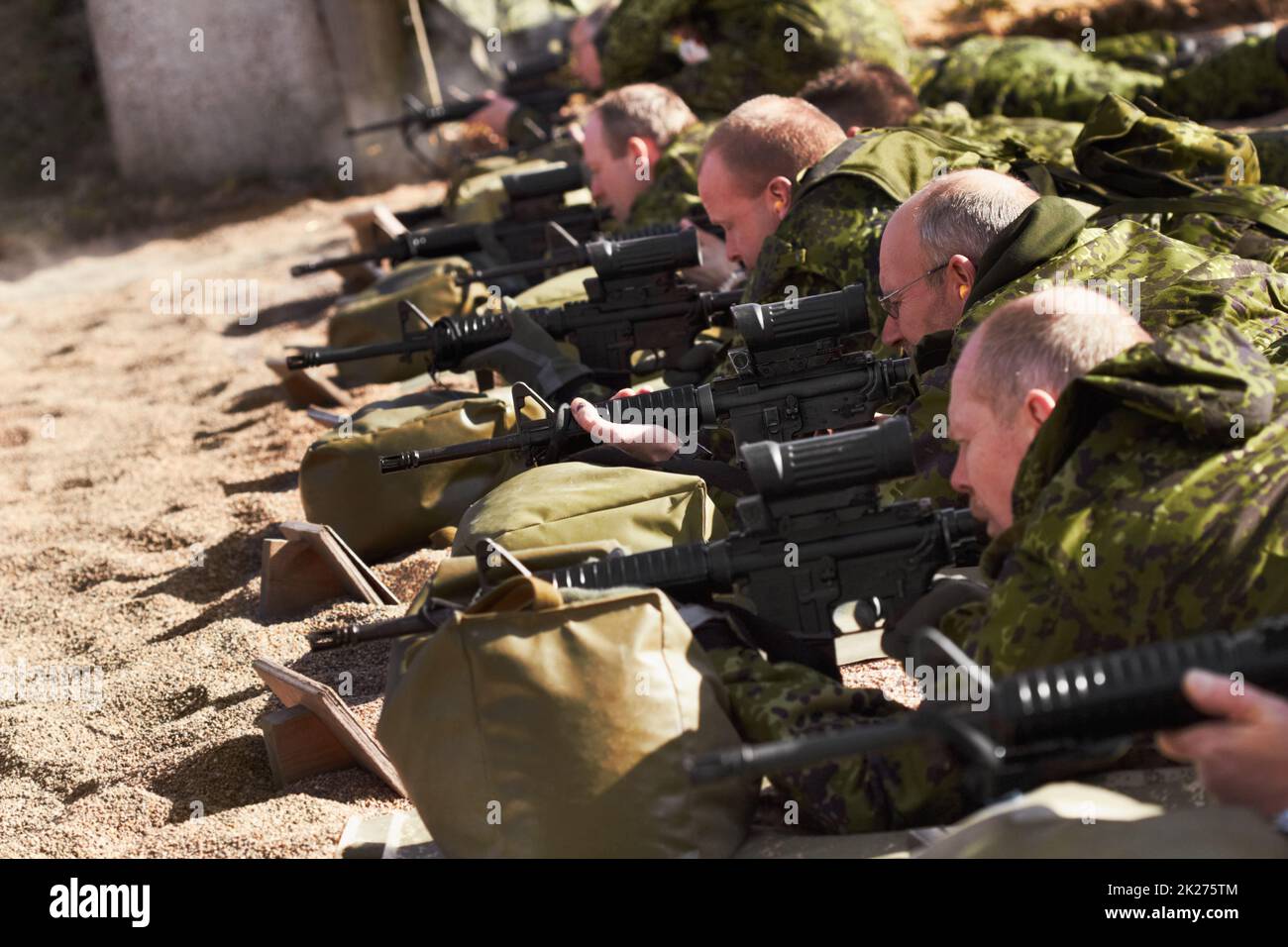 Training to be sharpshooters. A line of soldiers lying and aiming with ...