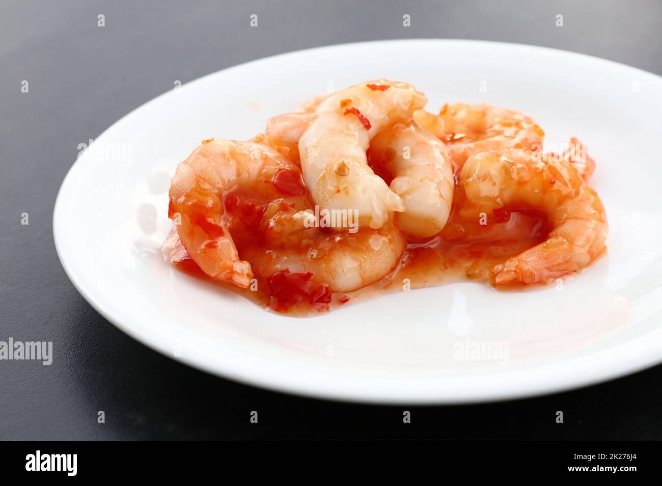 Portion of shrimps with chili sauce on plate Stock Photo - Alamy