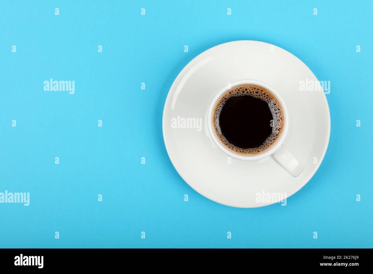 Full white espresso coffee cup over blue Stock Photo - Alamy