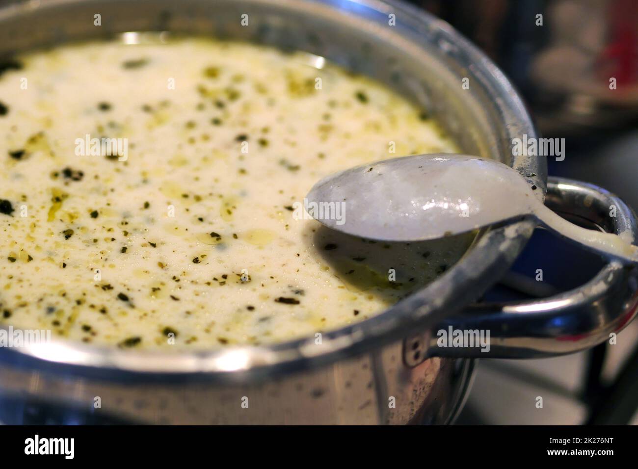 Boiling yoghurt soup on a freshly cooked stove, very hot yoghurt soup ...