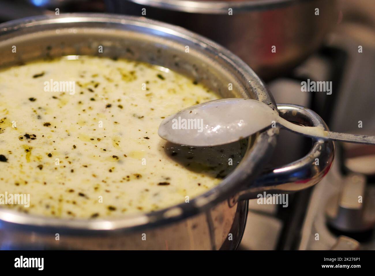 Boiling yoghurt soup on a freshly cooked stove, very hot yoghurt soup ...