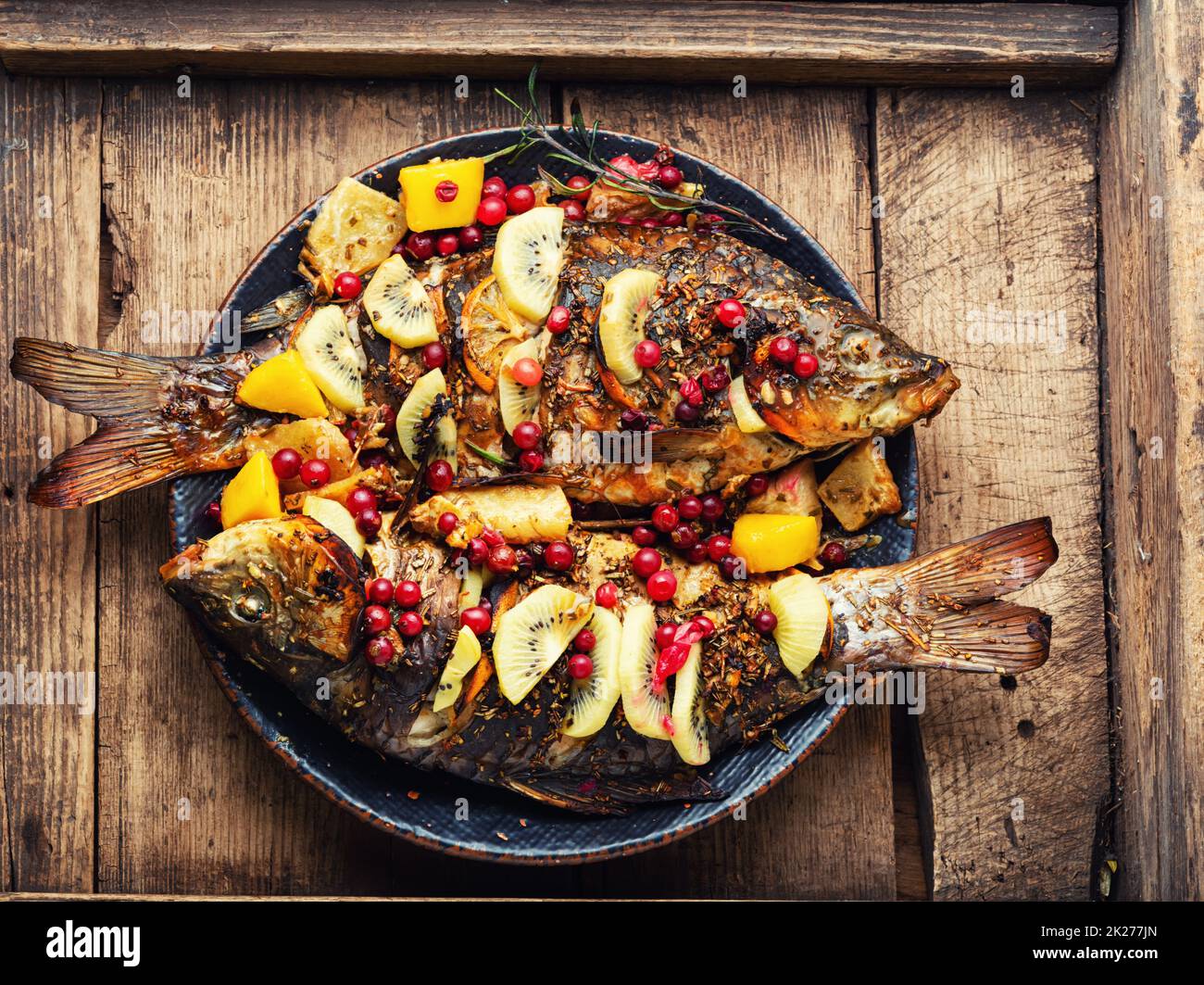 Delicious carp fried with kiwi and mango Stock Photo - Alamy