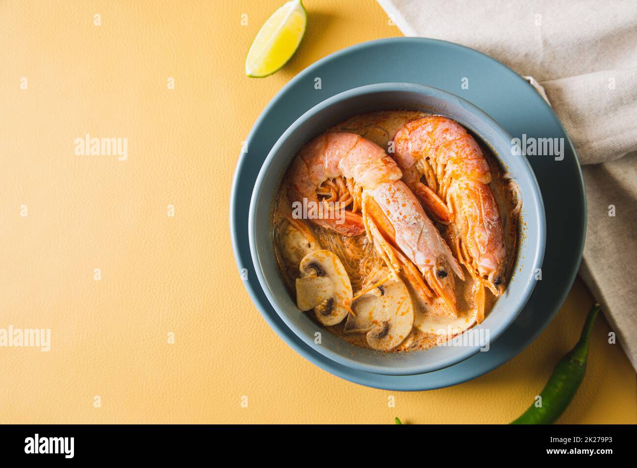 Tom Yum Goong Spicy Sour Soup on trendy table top view, Thai local food ...