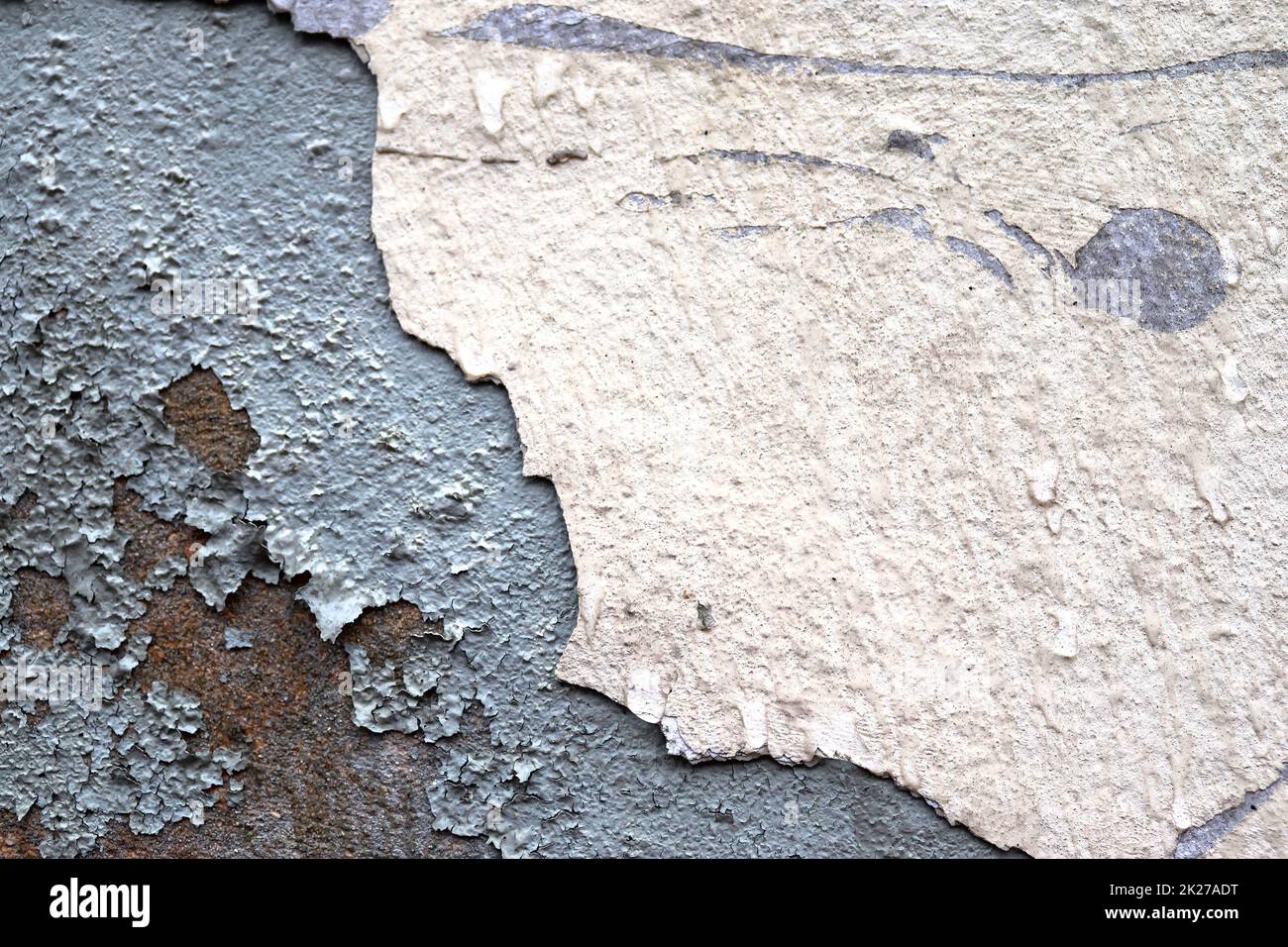 Detailed and colorful close up at cracked and peeling paint on concrete wall textures in high ...