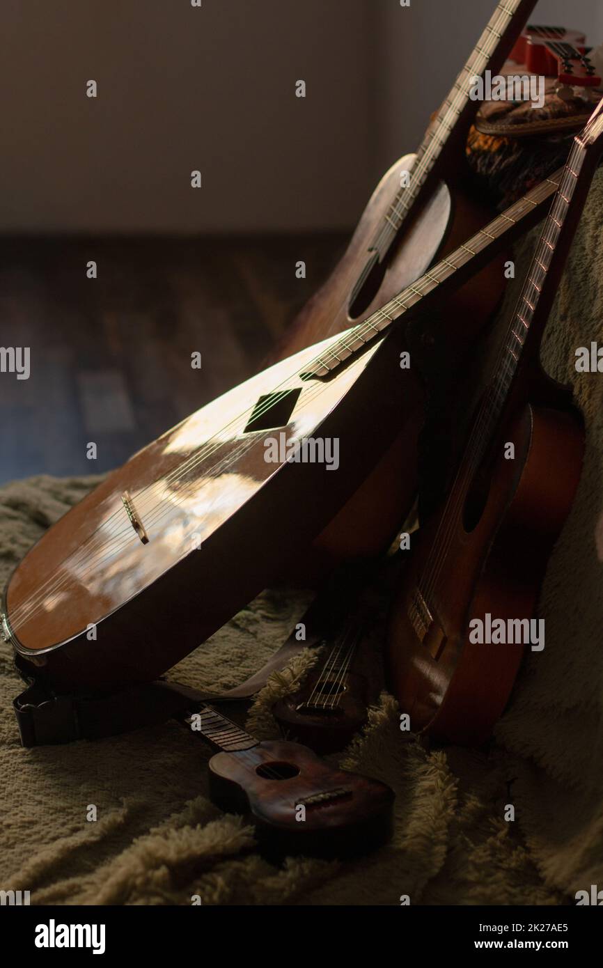 Stringed musical instruments, real and toy, lie on the couch Stock ...