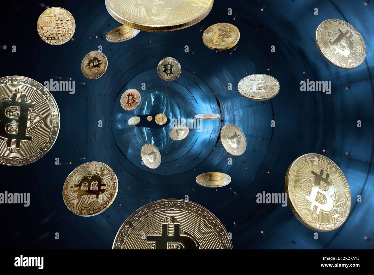 Crypto currency bitcoins fall into the black hole Stock Photo - Alamy