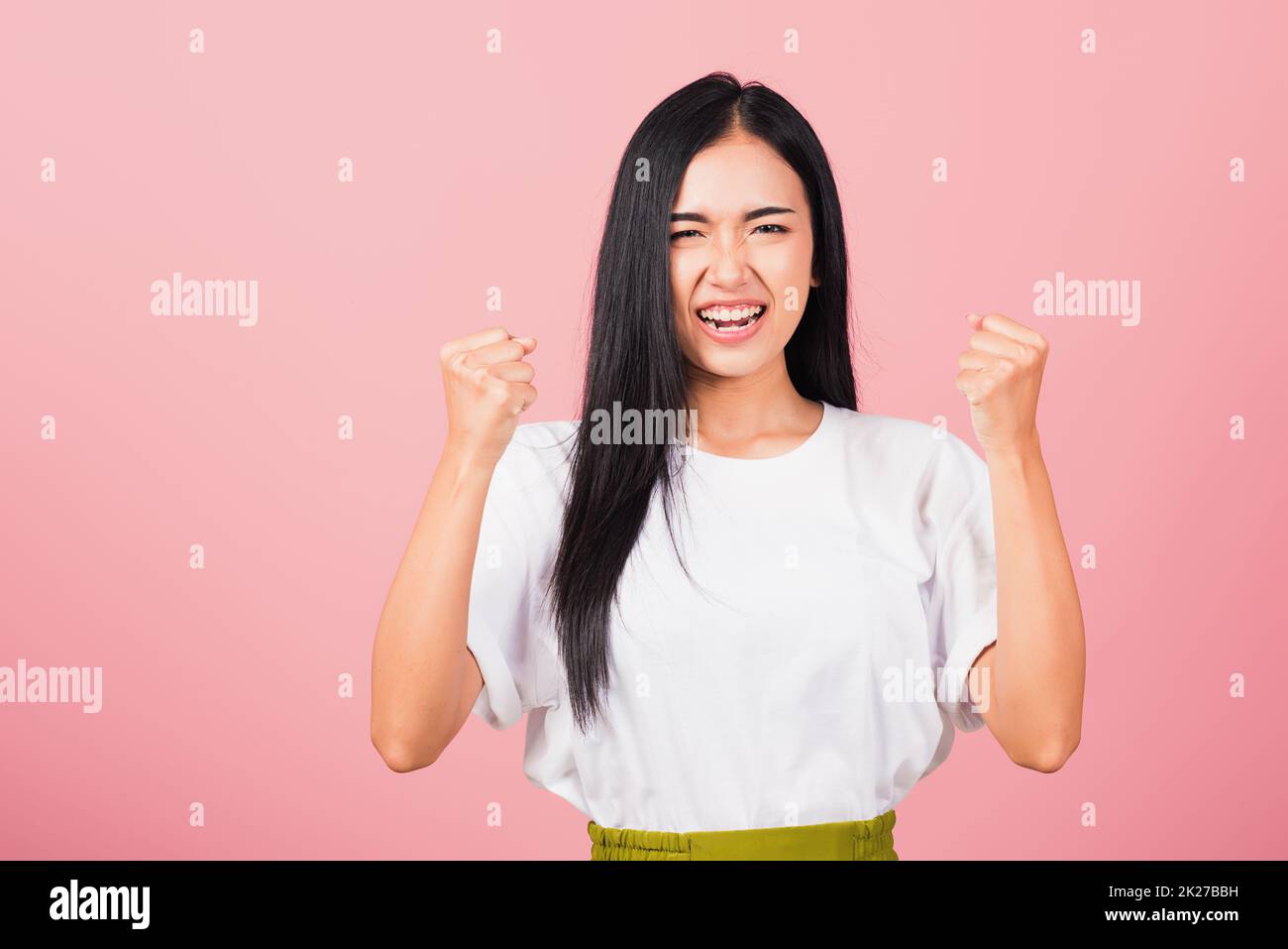 woman standing angry and mad raising fist frustrated and furious while ...