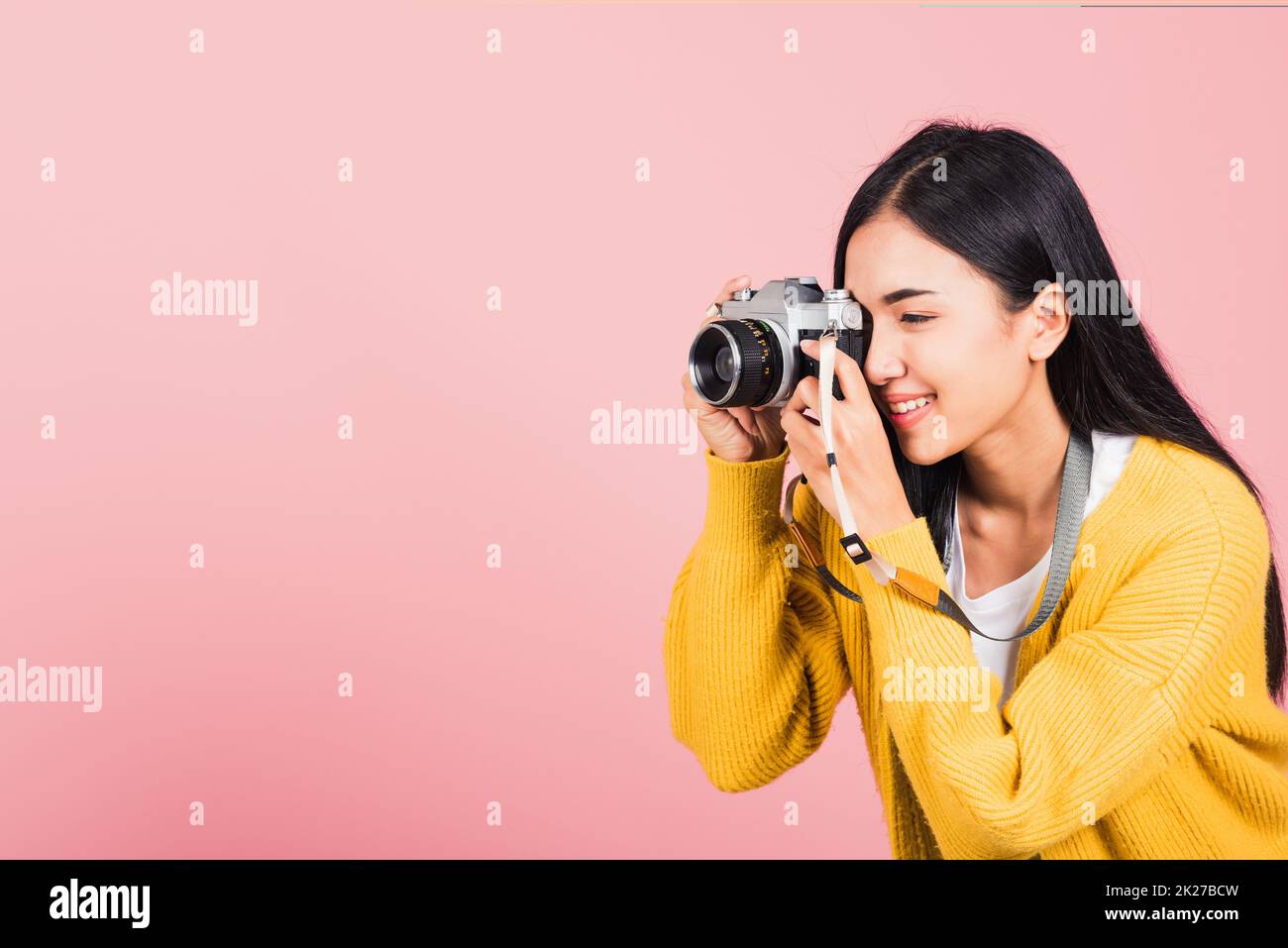 woman smiling photographer taking a picture and looking viewfinder on ...