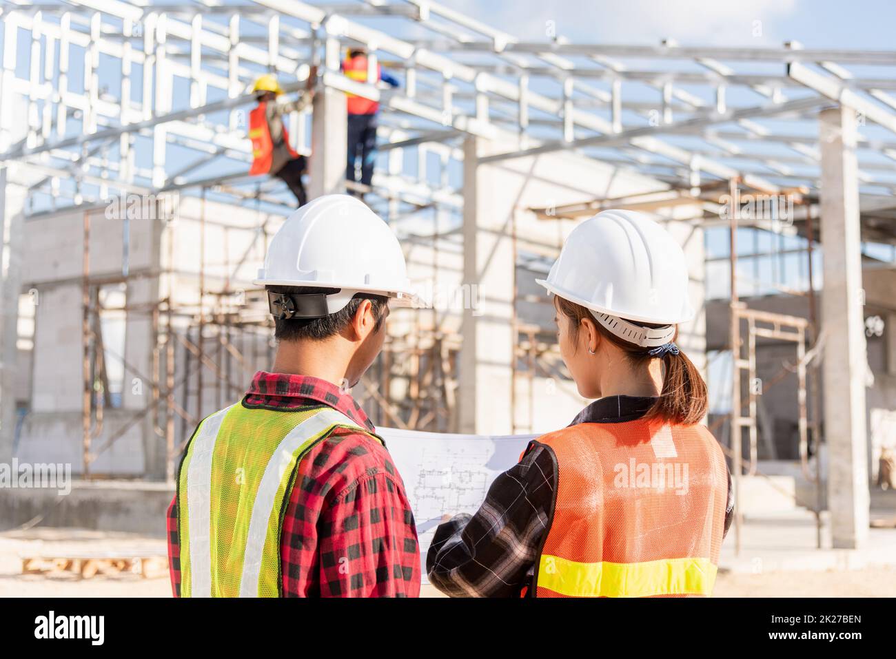 Back two architect and client discussing help create plan with ...