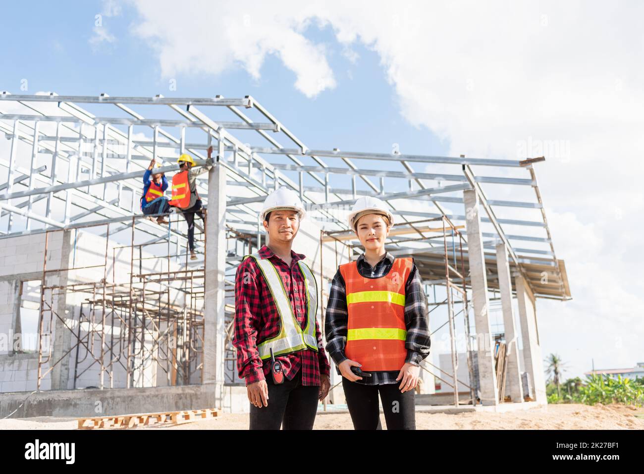 Architect and client standing at home building construction site Stock ...