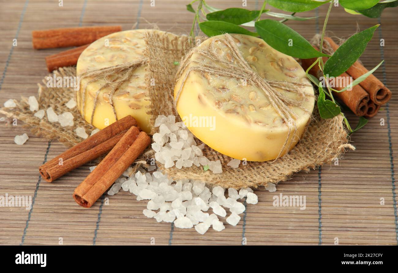 Hand-made soap and sea salt on grey bamboo mat Stock Photo - Alamy