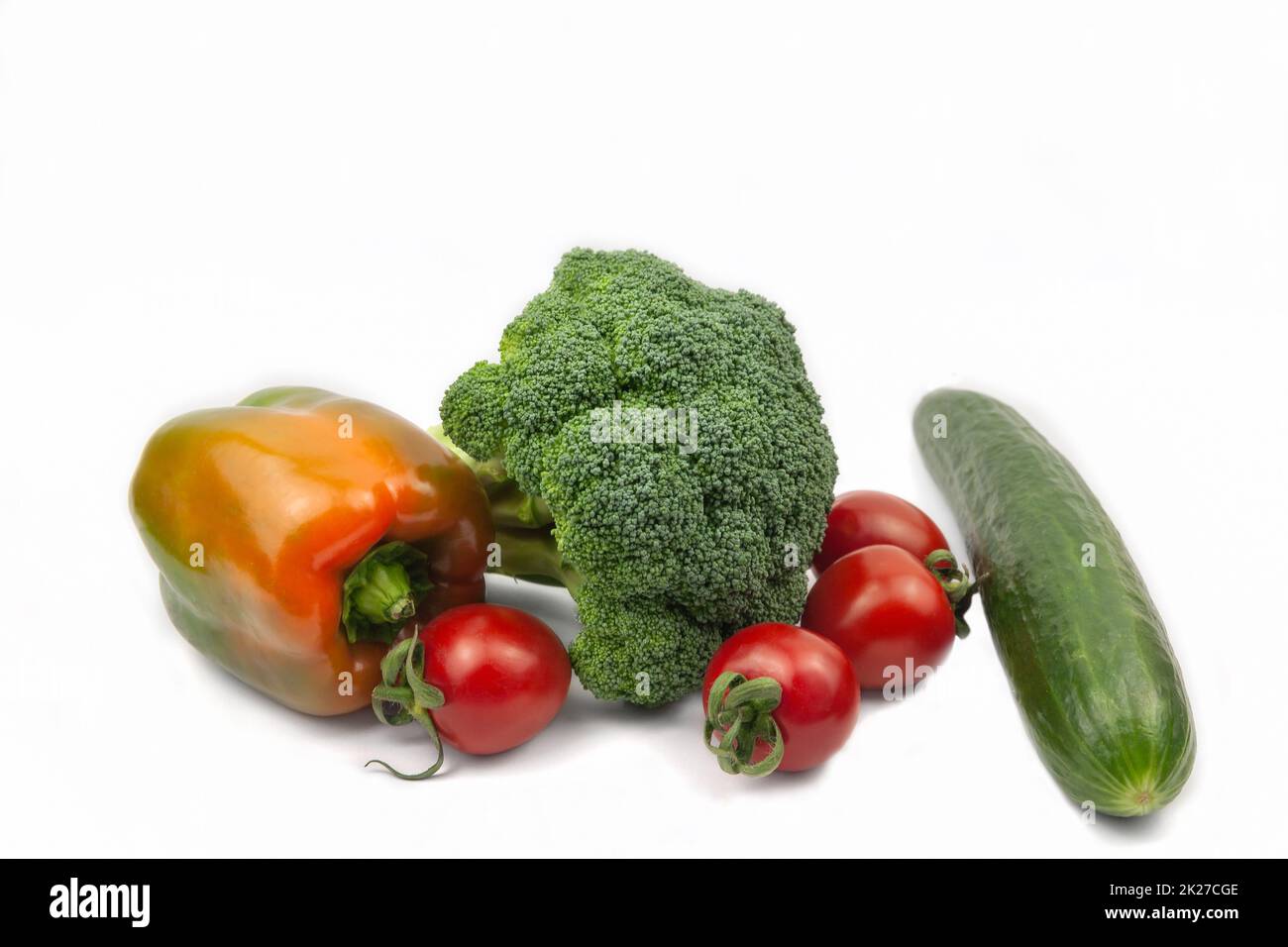 Fresh broccoli, cucumber, pepper and tomatoes on white background Stock ...