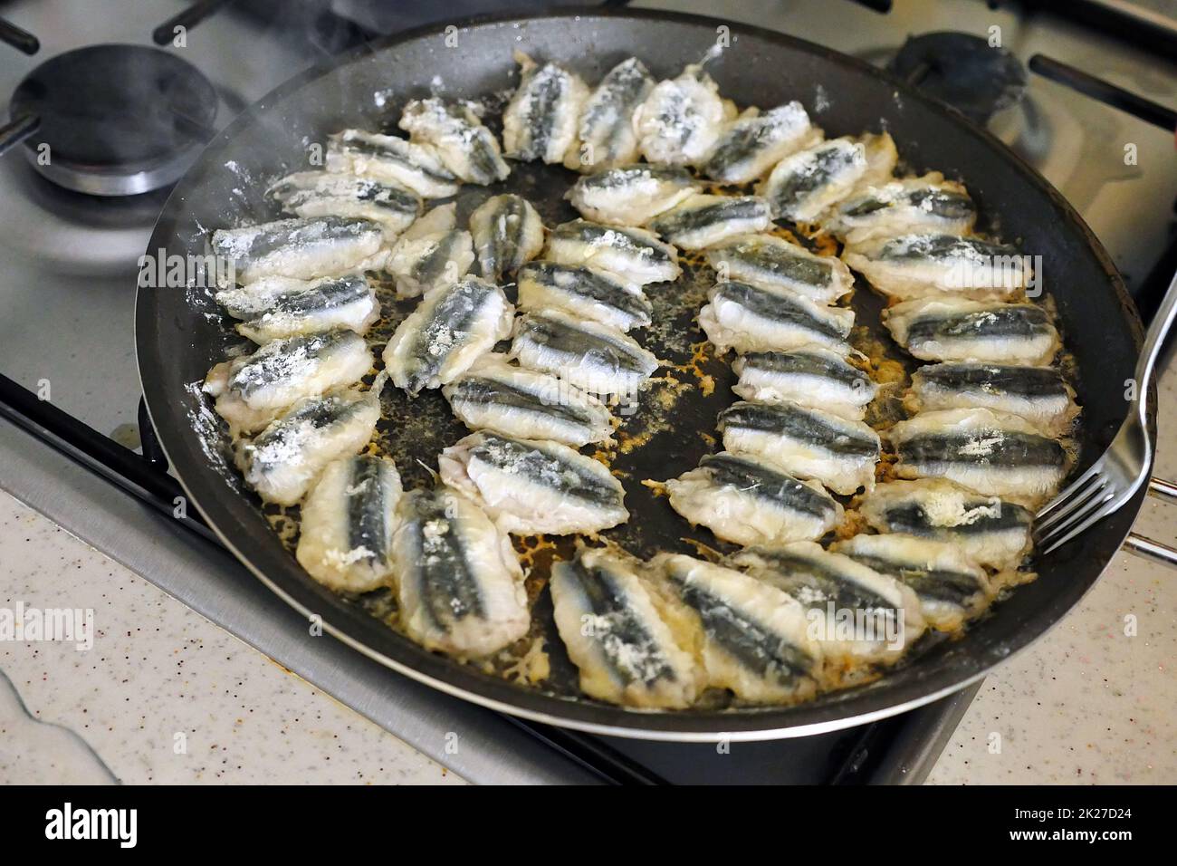 fish is about to fry in the pan, crispy fried fish, anchovy fish is ...