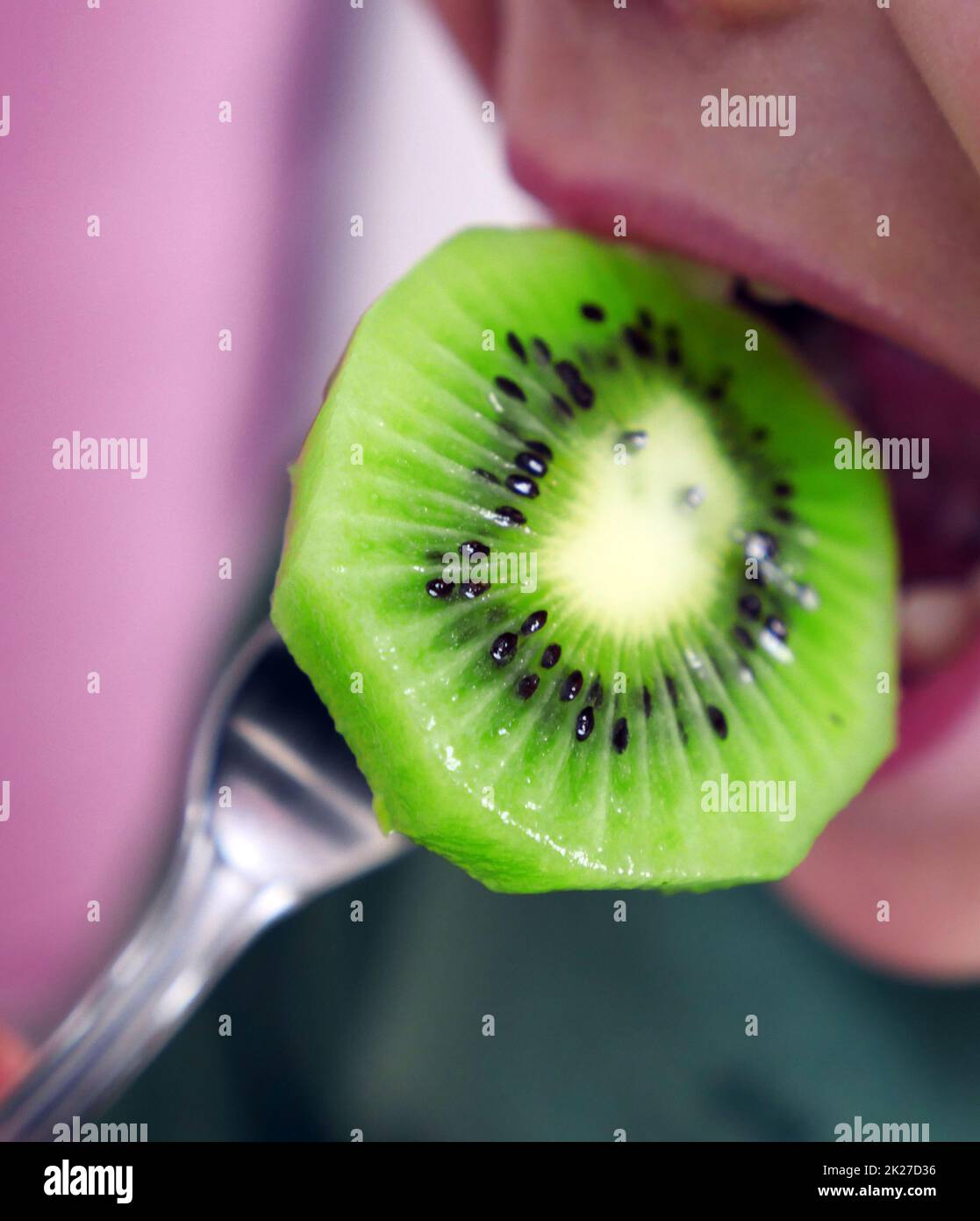 a sliced kiwi slice,close-up kiwi slice,a person eats kiwi fruit Stock ...