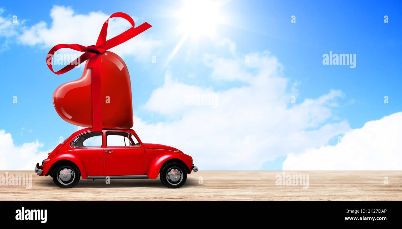Miniature retro car delivering heart for Valentine's day Stock Photo ...
