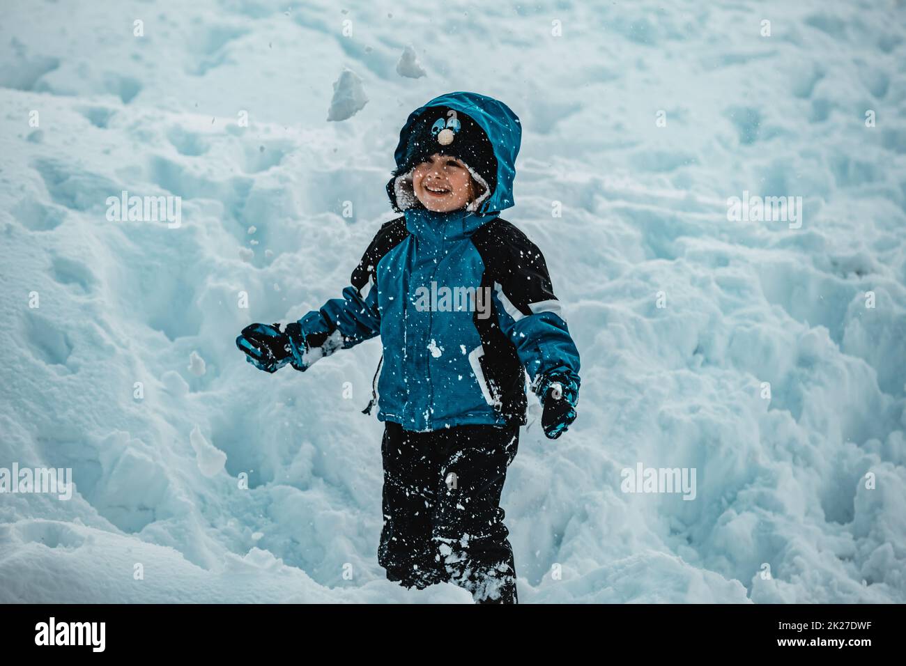 Baby Boy Playing with Snow Stock Photo - Alamy