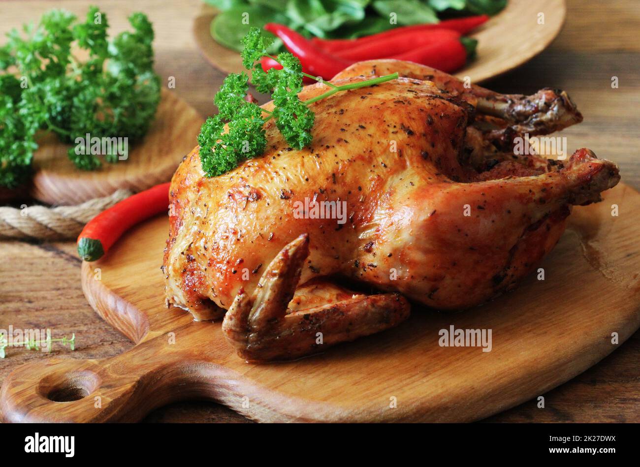 Whole roasted chicken on cutting board Stock Photo - Alamy