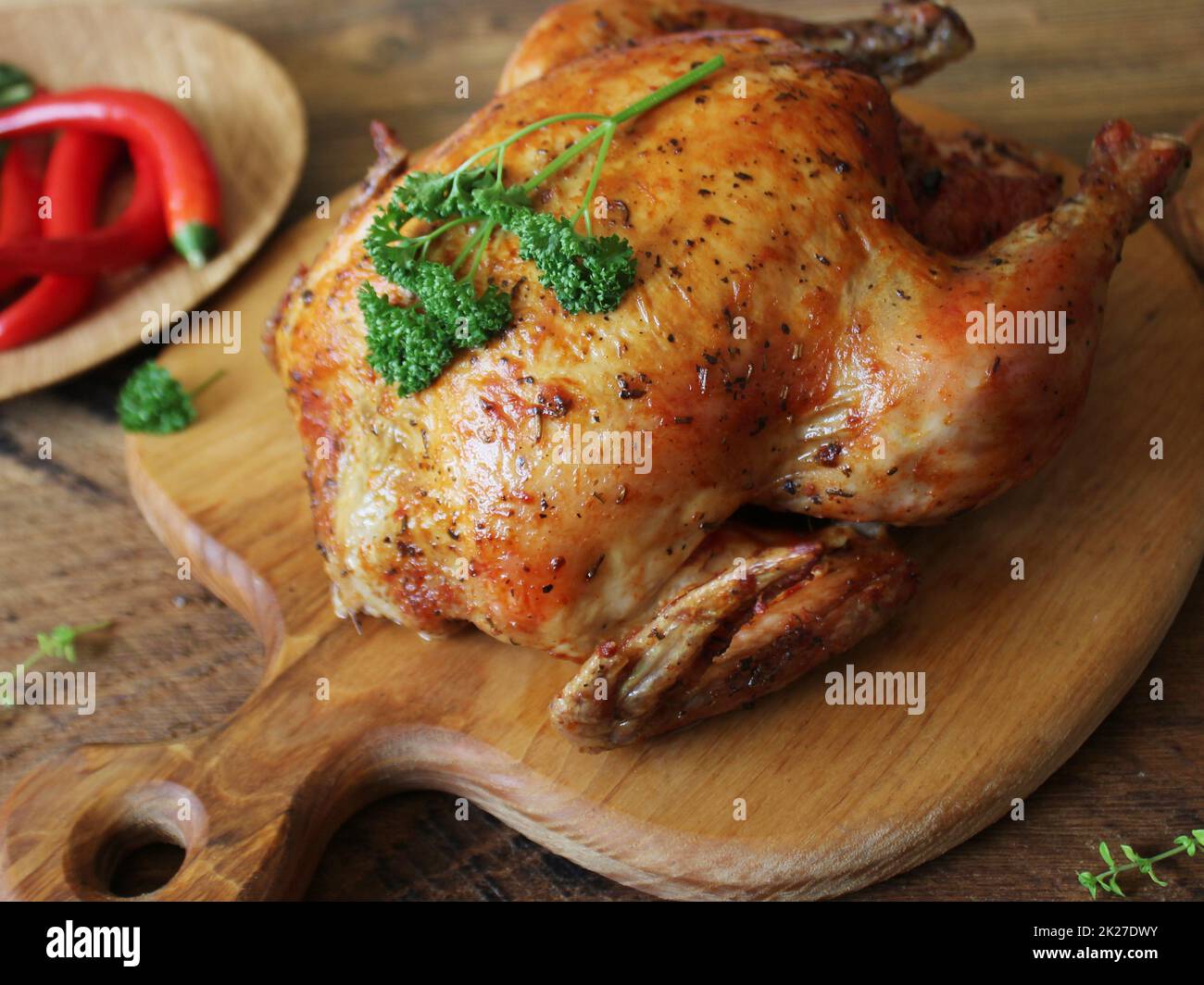 Whole roasted chicken on cutting board Stock Photo - Alamy
