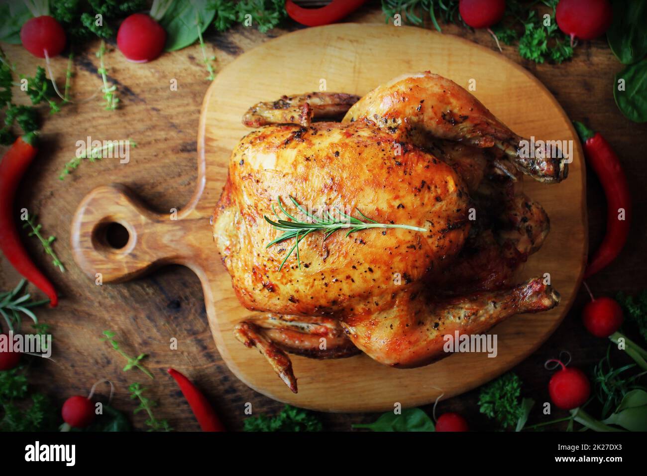 Whole roasted chicken on cutting board Stock Photo - Alamy