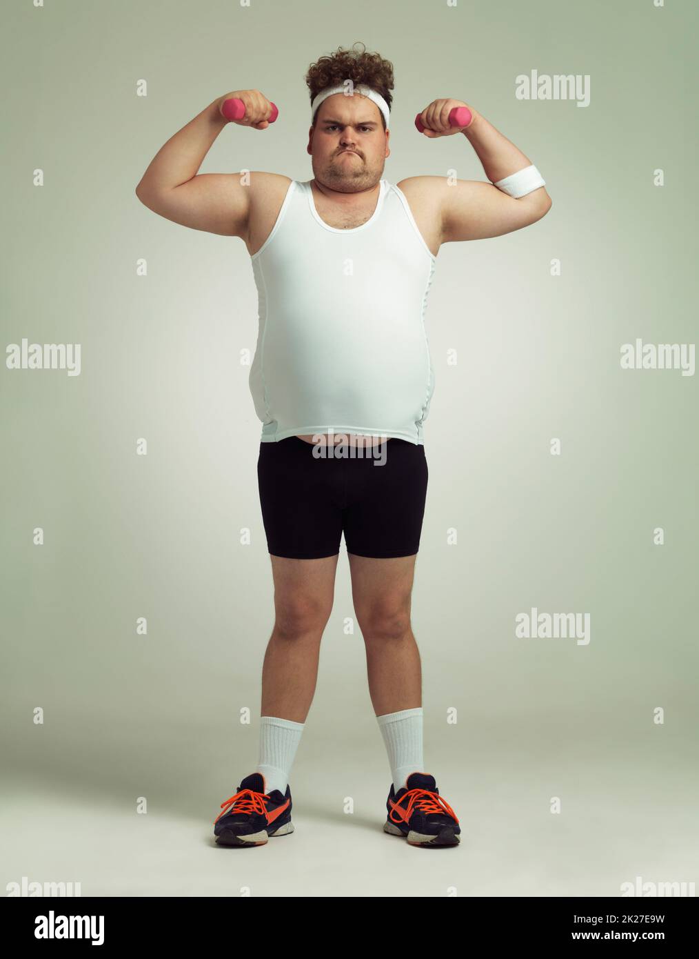 Optimal Muscle Angel Check An Overweight Man Holding Up Dumbbells