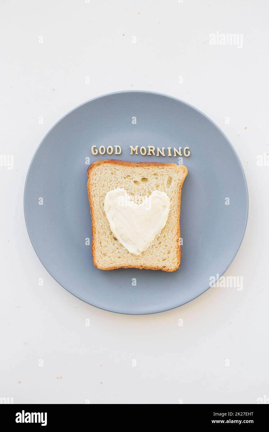 sandwich for breakfast in form of heart with cheese on a blue plate ...