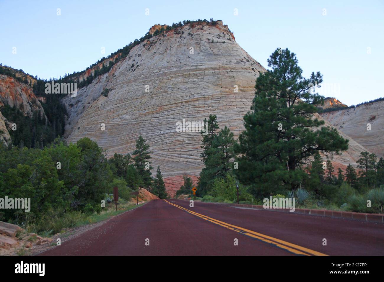 The red paved road towards the white Checkerboard Mesa during a summer ...