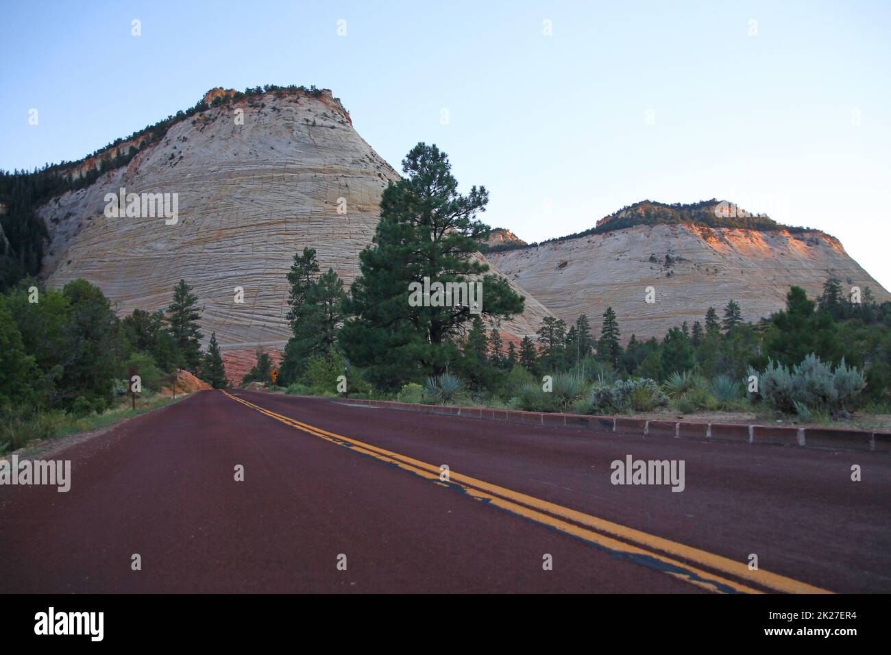 The red paved road towards the white Checkerboard Mesa during a summer ...