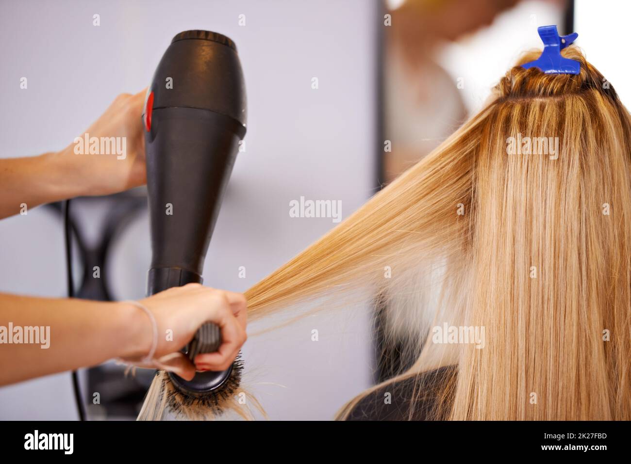Shes going to look stunning after this. A young woman having her hair ...