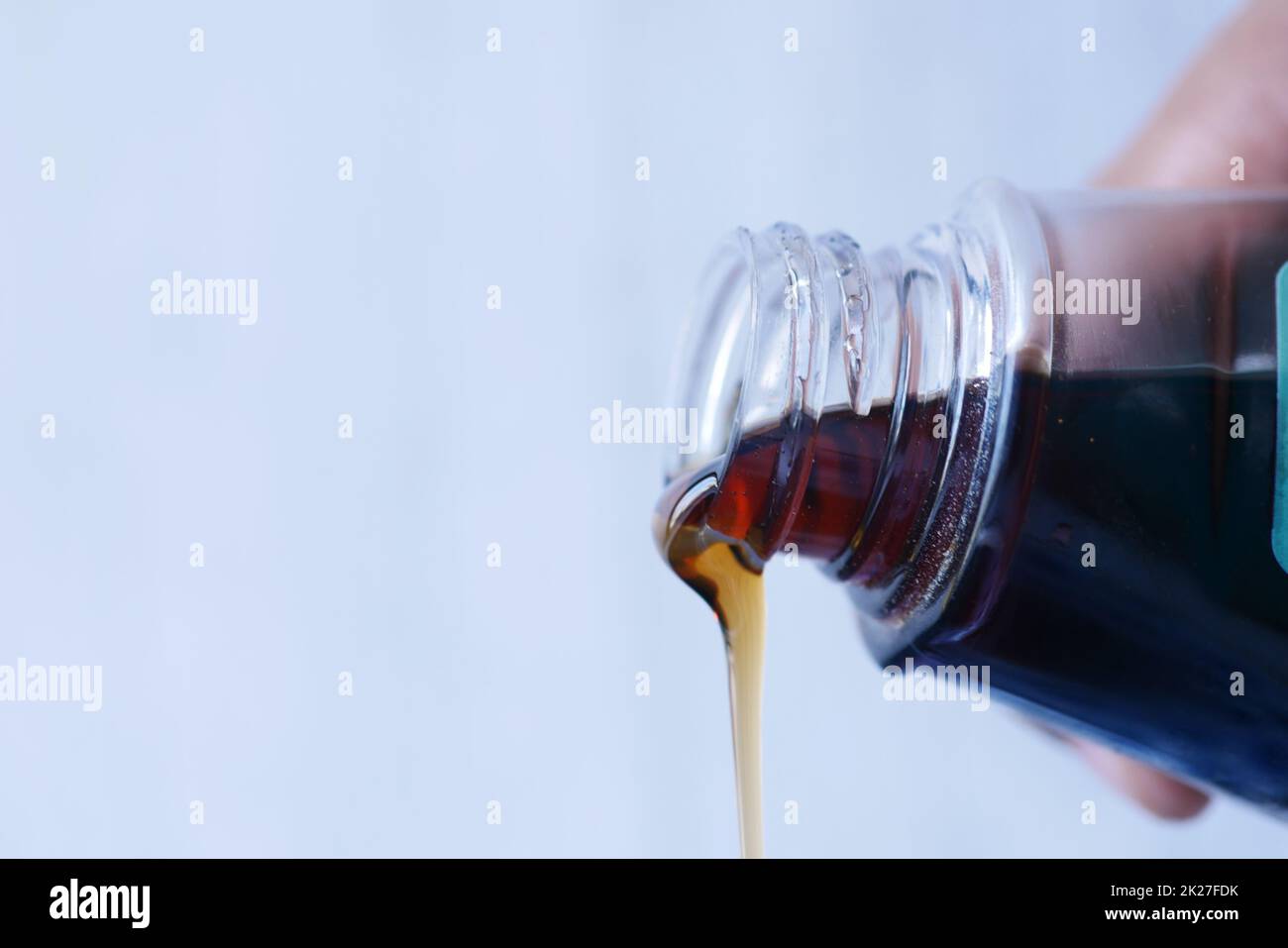 Bottle of maple syrup pouring close up Stock Photo - Alamy