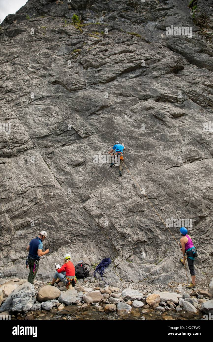 Climber scaling steep rock face hi-res stock photography and images - Alamy