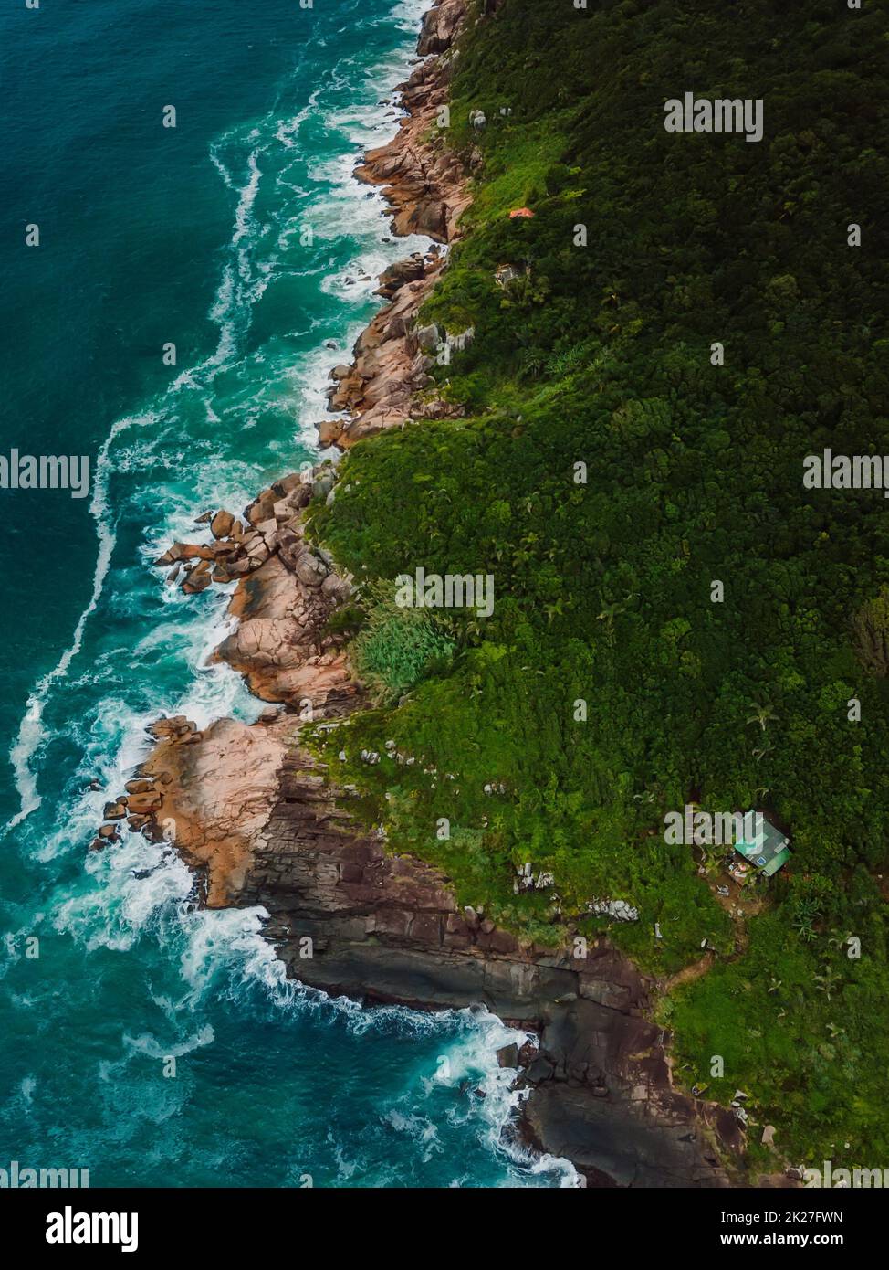 Scenic ocean coastline with alone house and rocks with waves in Brazil ...