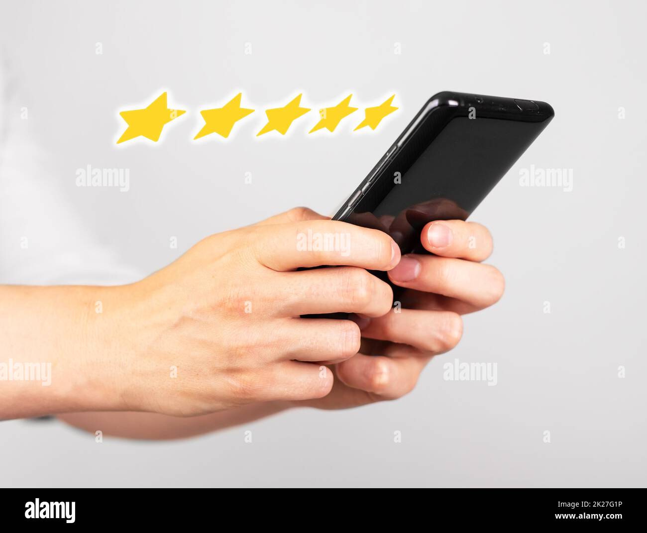 Hands holding phone for giving five star feedback. Satisfaction survey ...