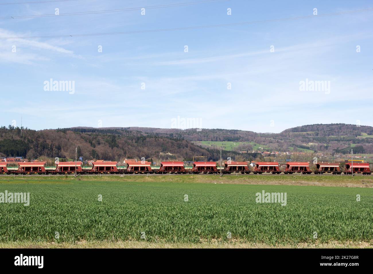 Cargo train to transport mineral materials crossing the field Stock ...