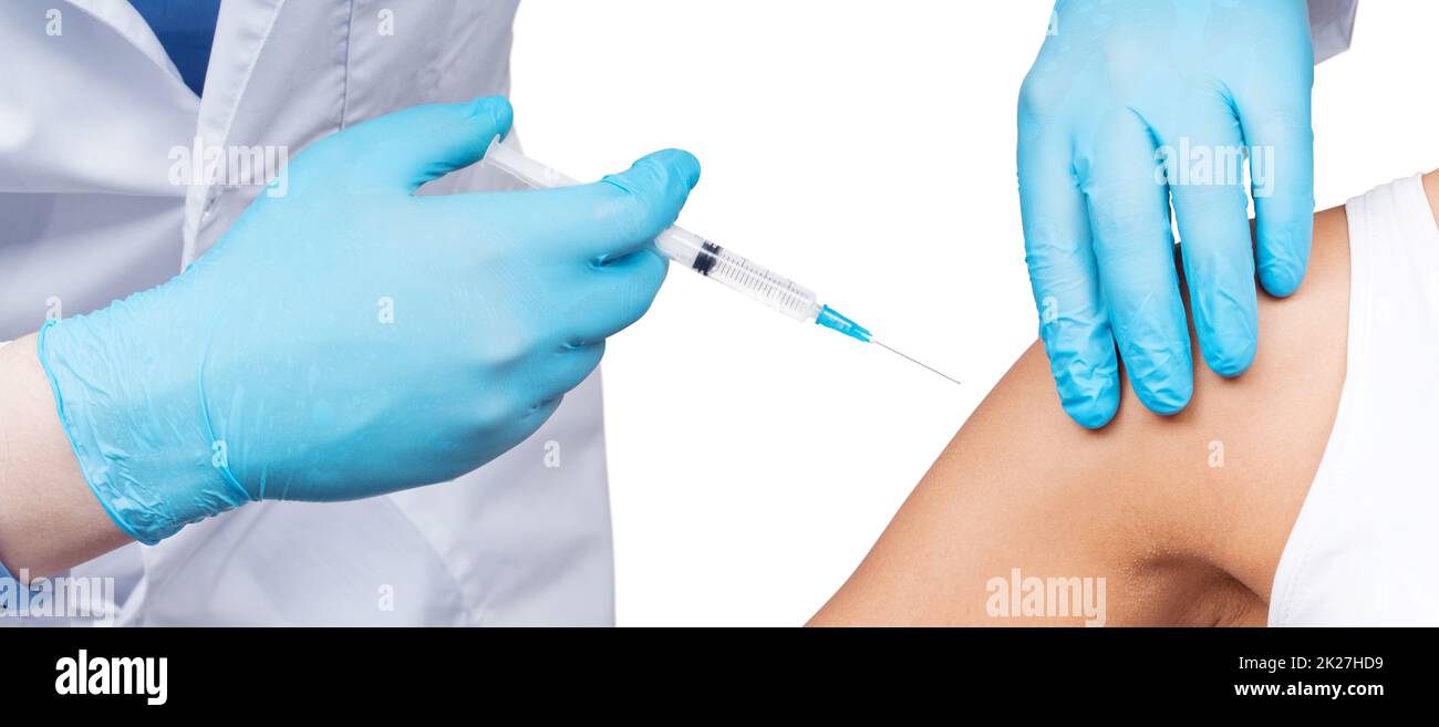 Doctor gives a syringe with vaccine to patient at clinic Stock Photo ...