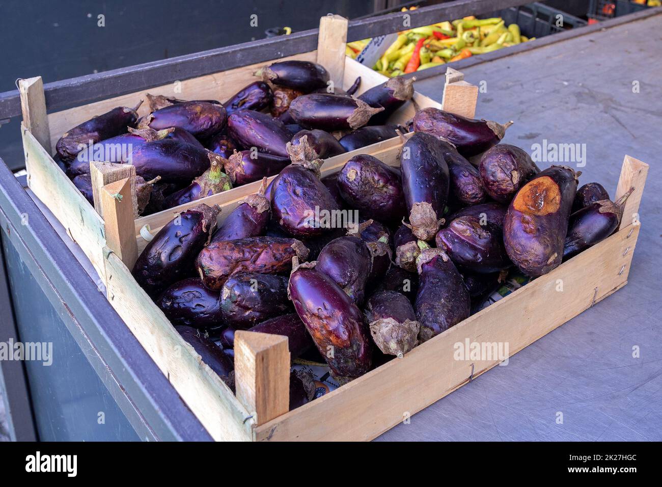 Aubergine vegetable in market crate gone bad Stock Photo - Alamy