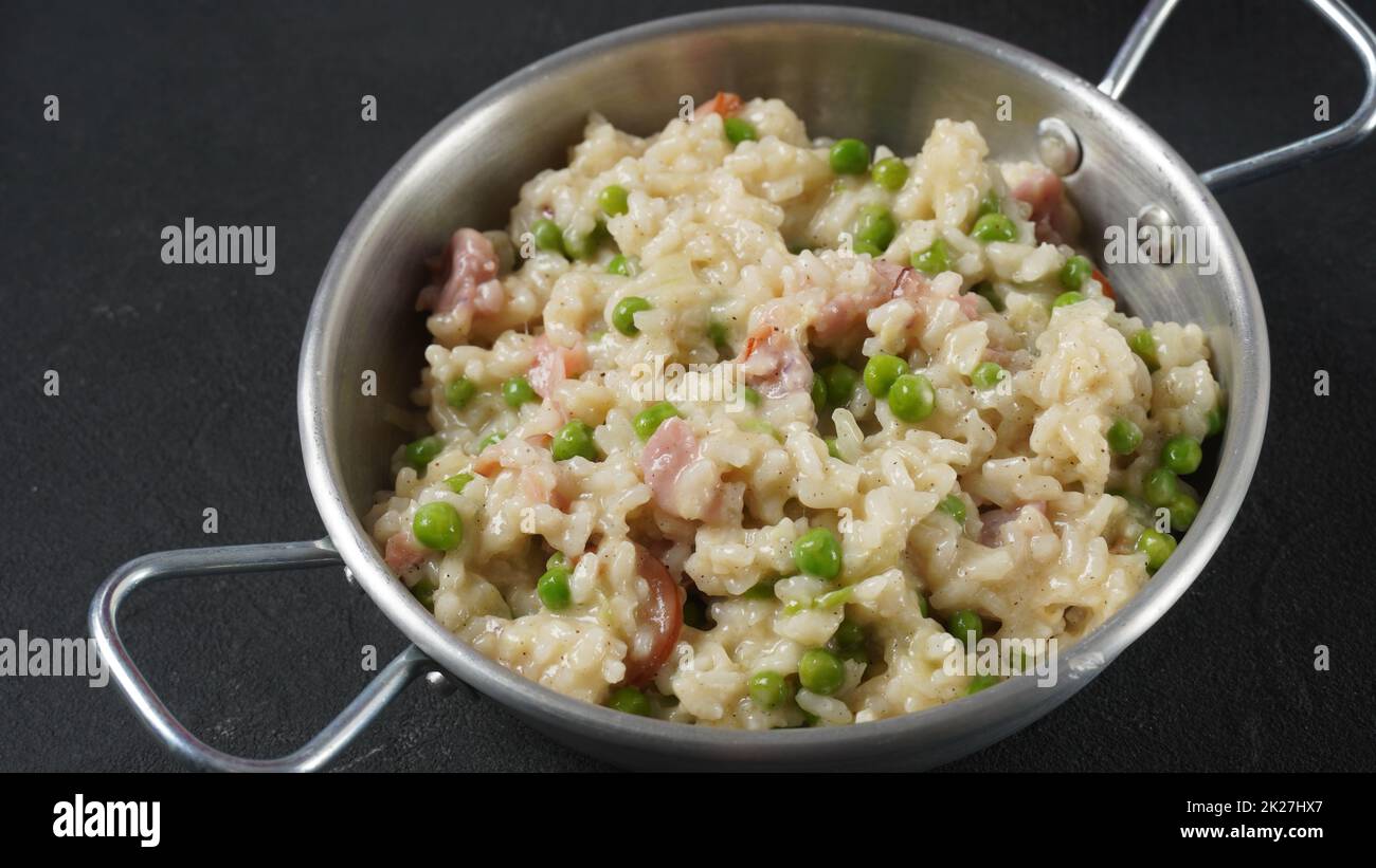 Classic italian risotto with peas, cheese parmesan, prosciutto. Risi e ...
