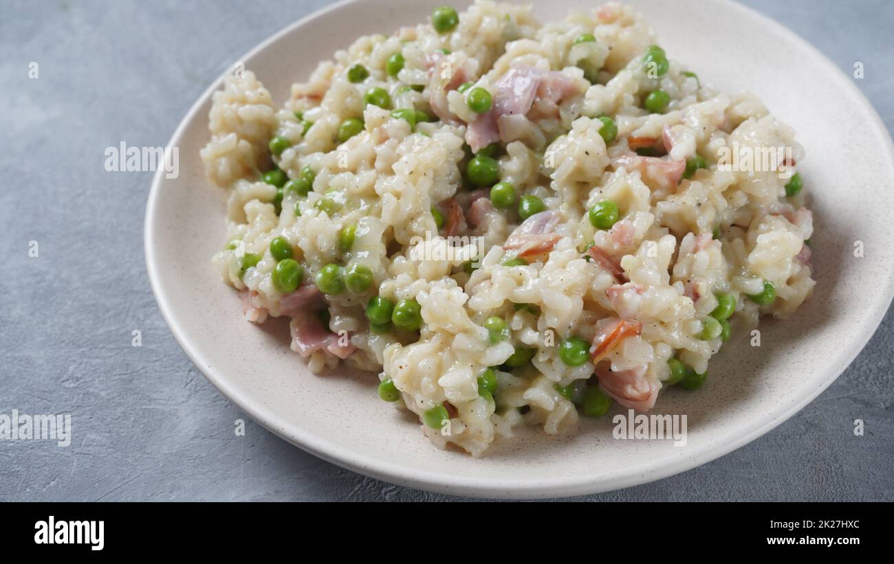 Classic italian risotto with peas, cheese parmesan, prosciutto. Risi e ...