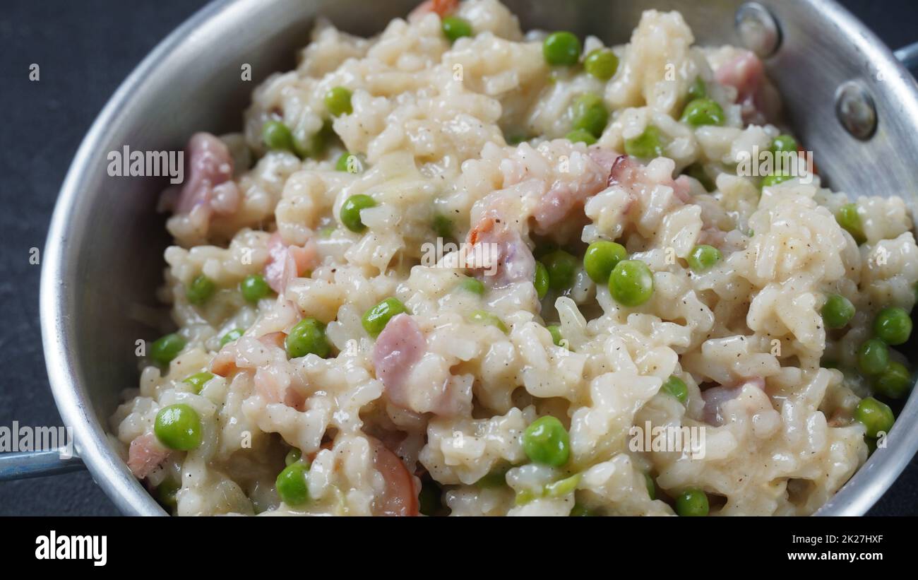 Classic italian risotto with peas, cheese parmesan, prosciutto. Risi e ...