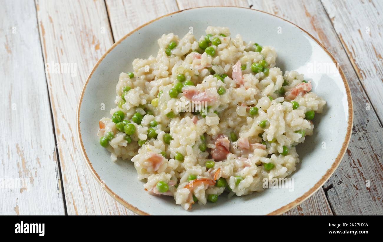 Classic italian risotto with peas, cheese parmesan, prosciutto. Risi e ...