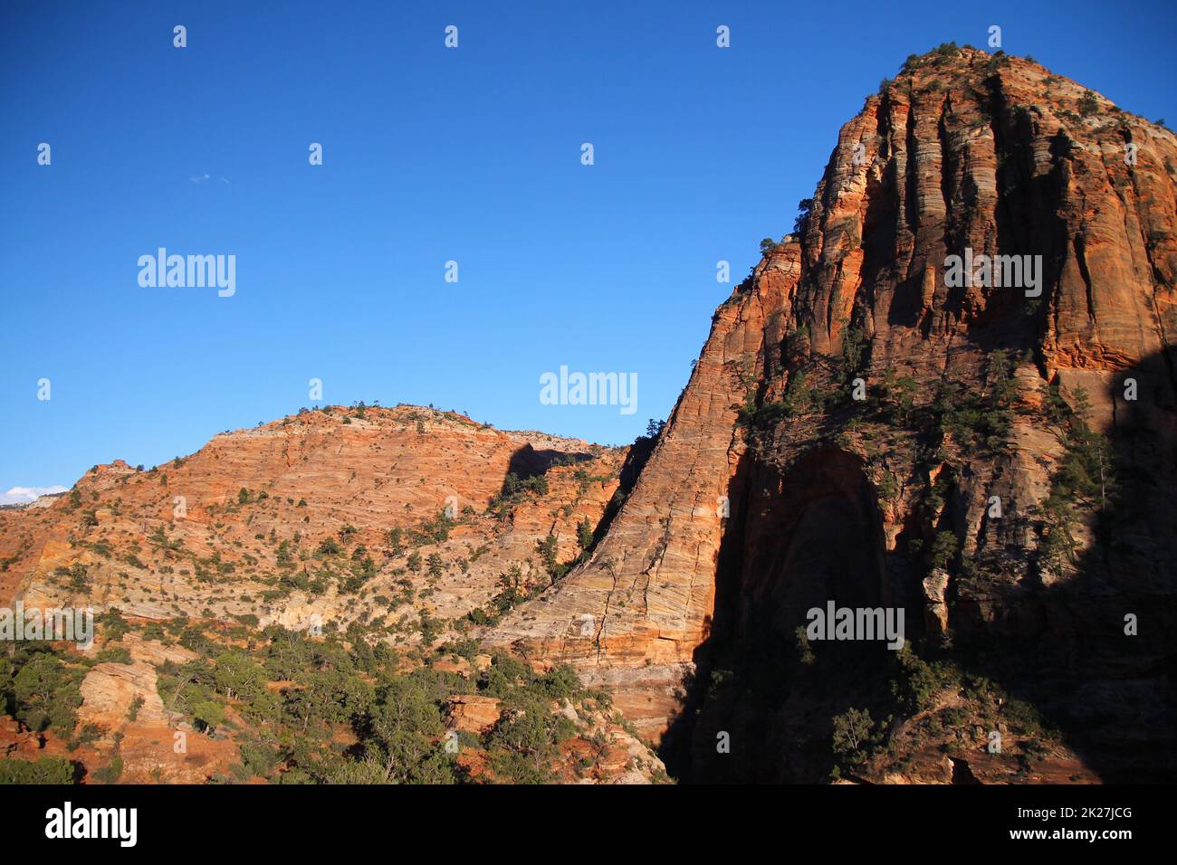 The vertical slope from a peak in Zion National Park during sunset ...