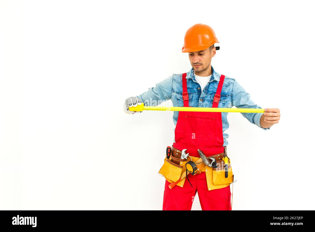 Construction worker pulling a rope. Full length studio shot isolated on ...